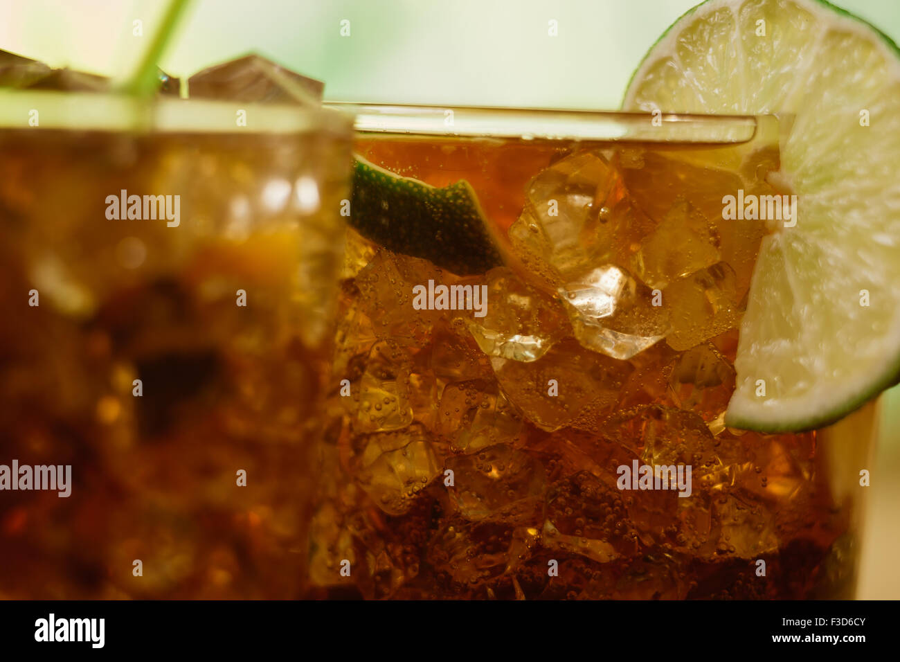 drink concept - cocktail with cola ice cubes and lime Stock Photo - Alamy