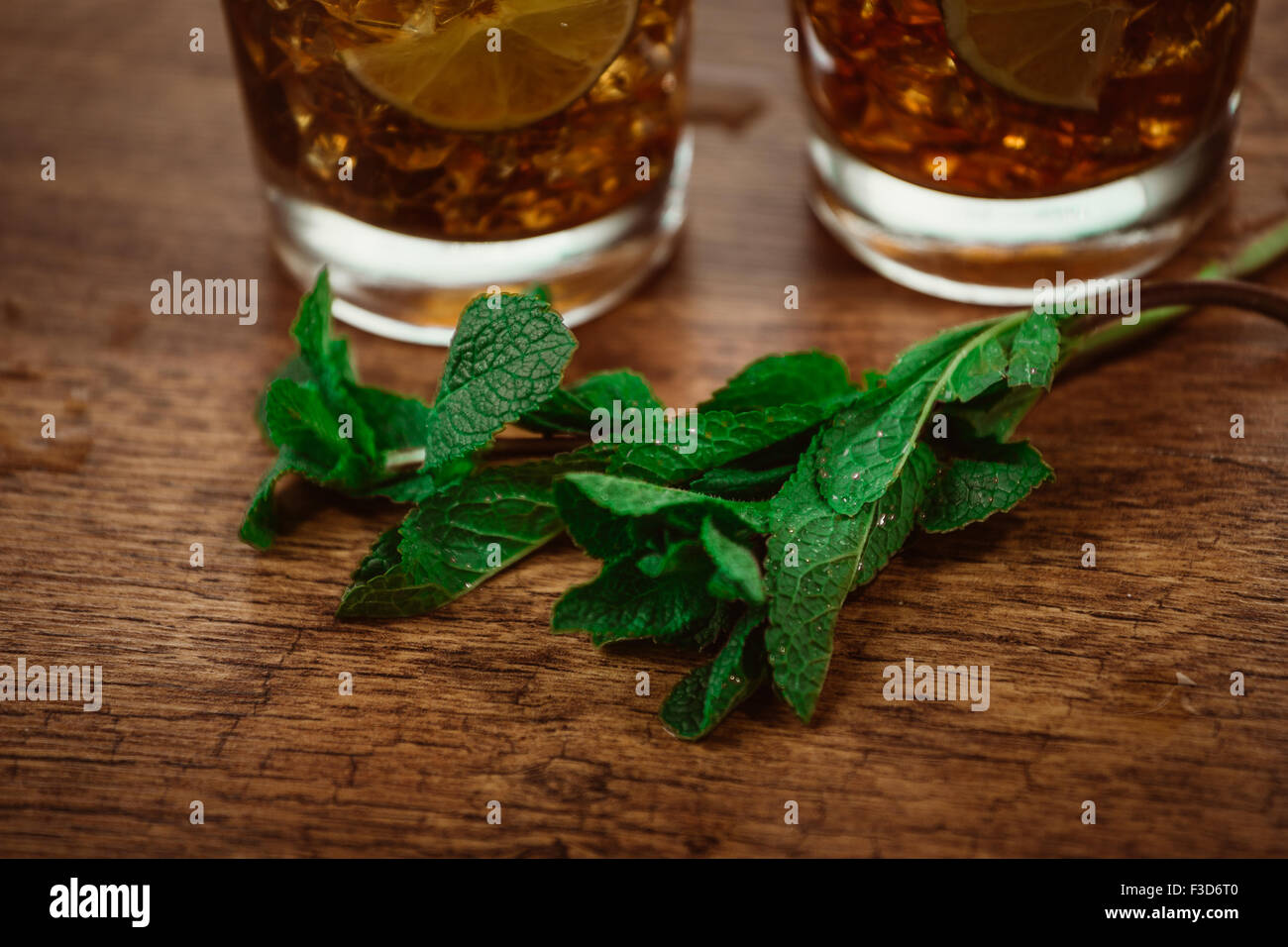 drink concept - cocktail with cola ice cubes and lime Stock Photo - Alamy