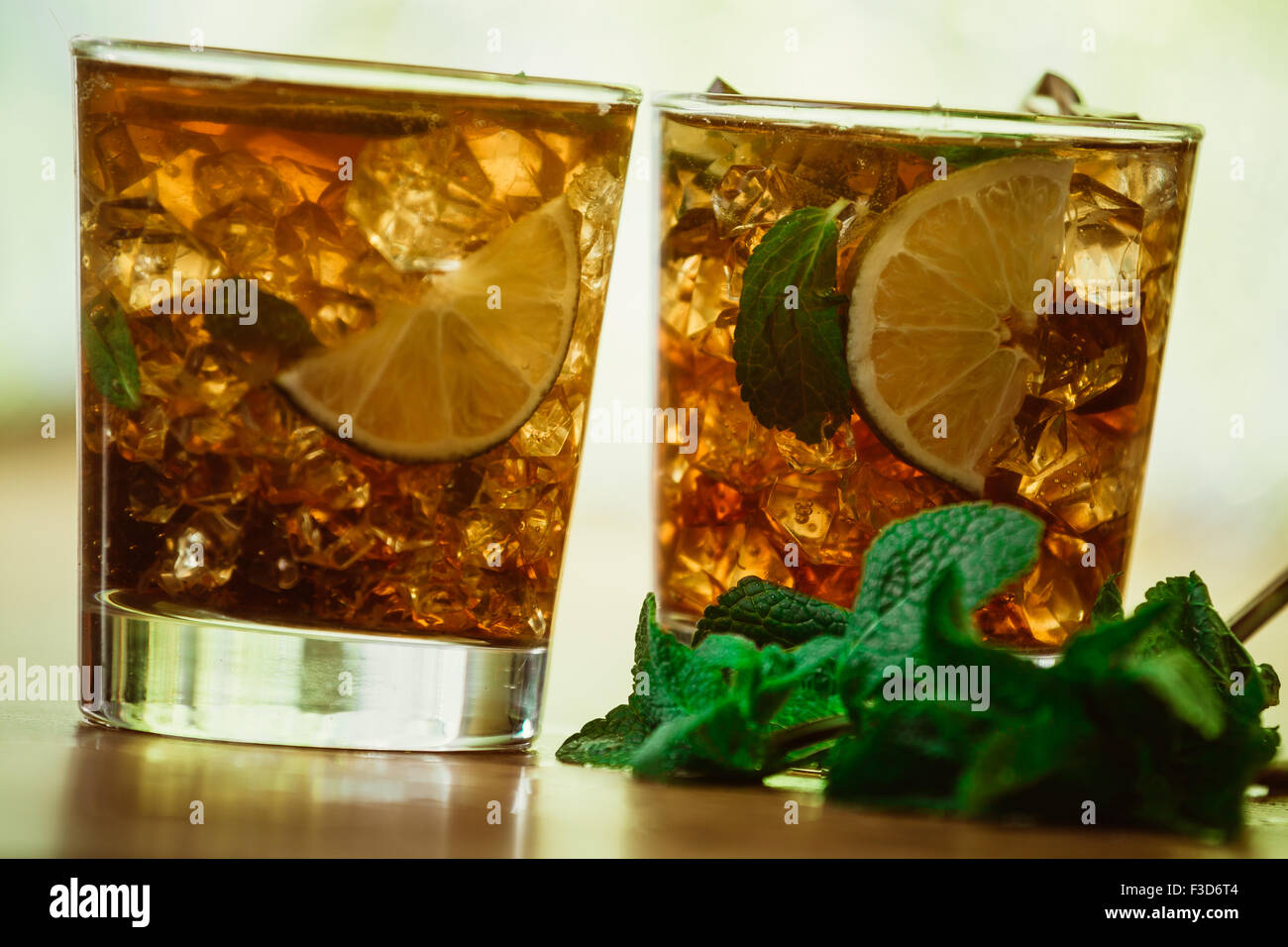 drink concept - cocktail with cola ice cubes and lime Stock Photo - Alamy