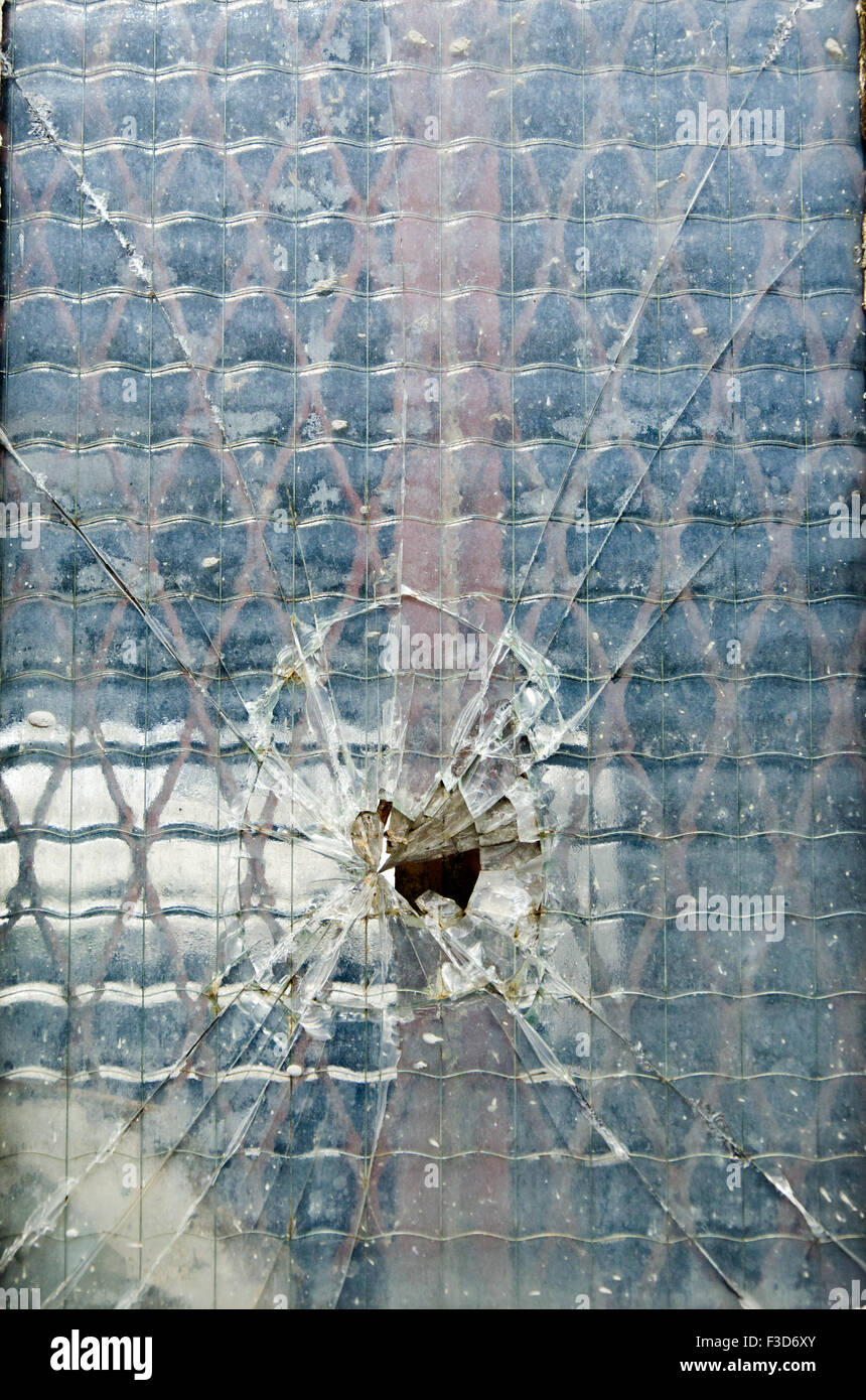 Broken window pane as vandalism act Stock Photo - Alamy