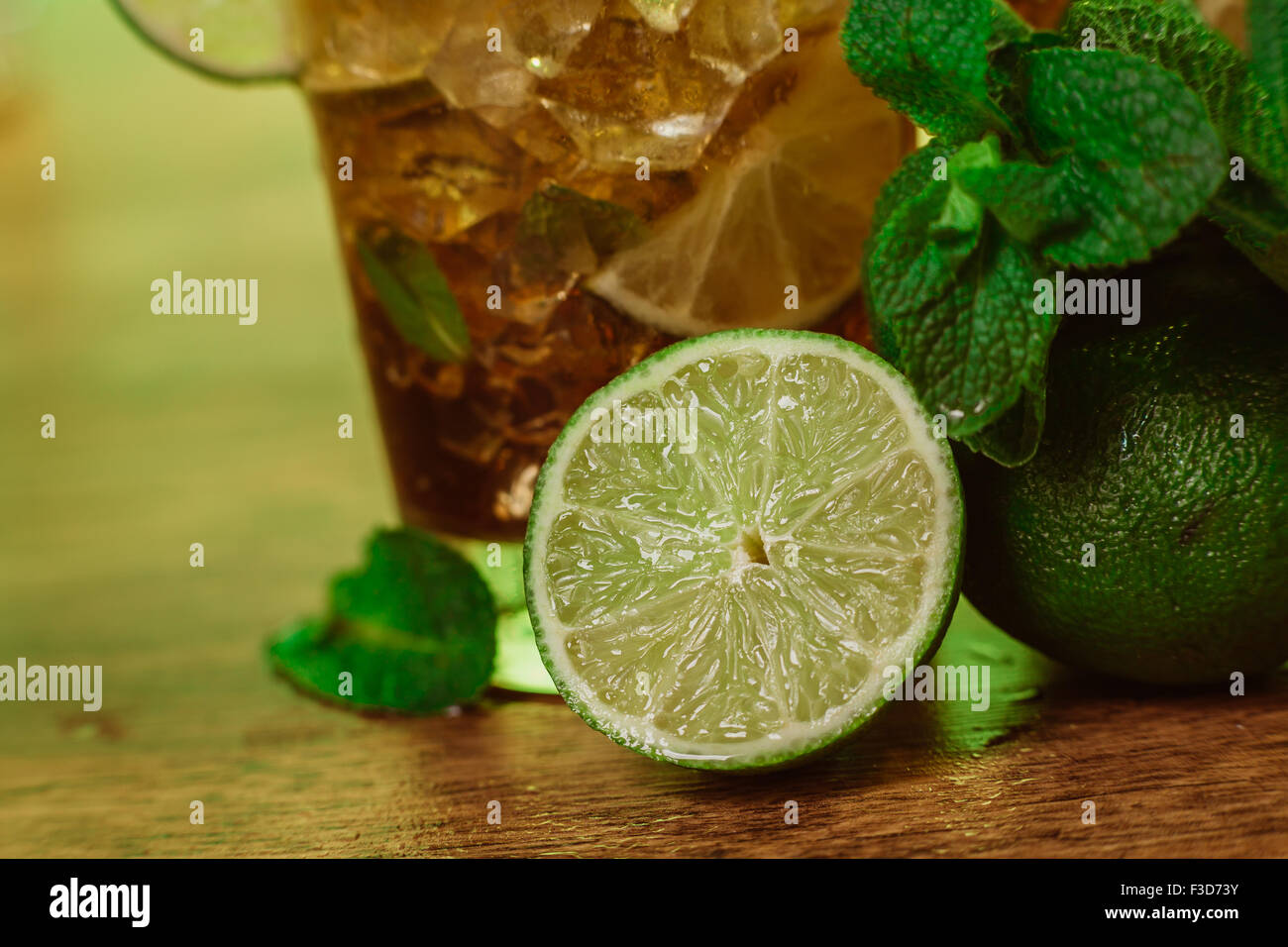 drink concept - cocktail with cola ice cubes and lime Stock Photo - Alamy