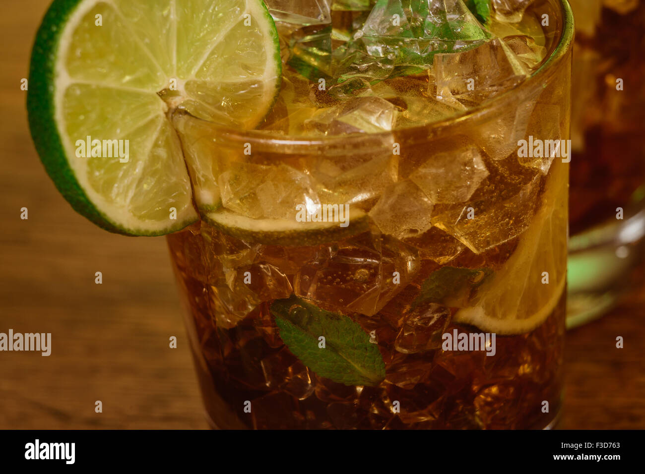 drink concept - cocktail with cola ice cubes and lime Stock Photo - Alamy