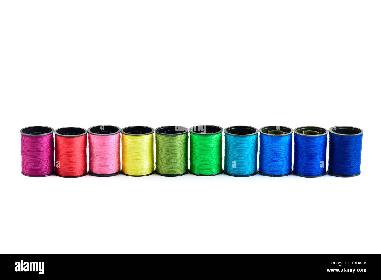 Sewing threads multicolored at white background Stock Photo - Alamy