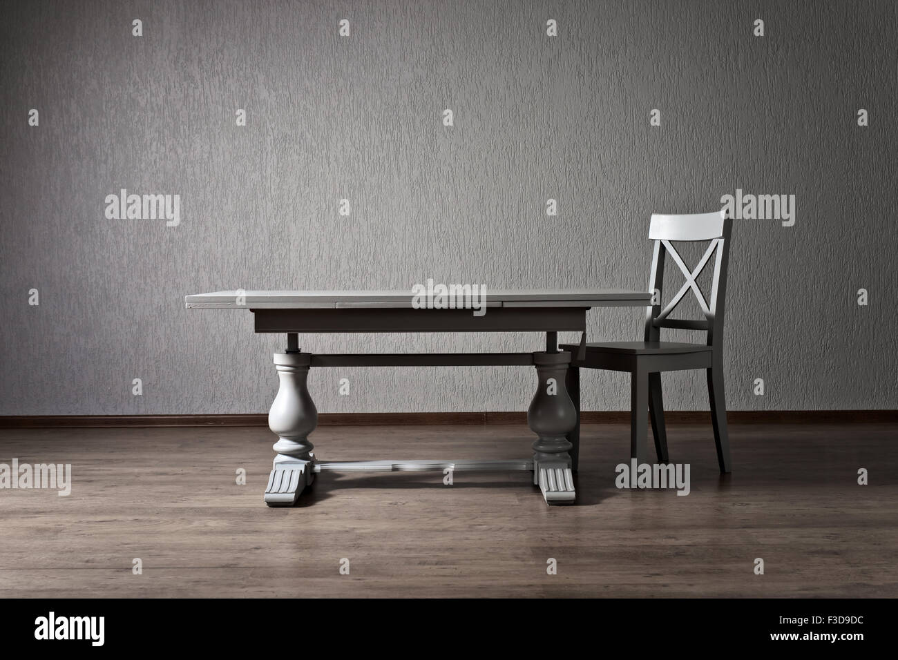 table and chair in empty grey room Stock Photo - Alamy