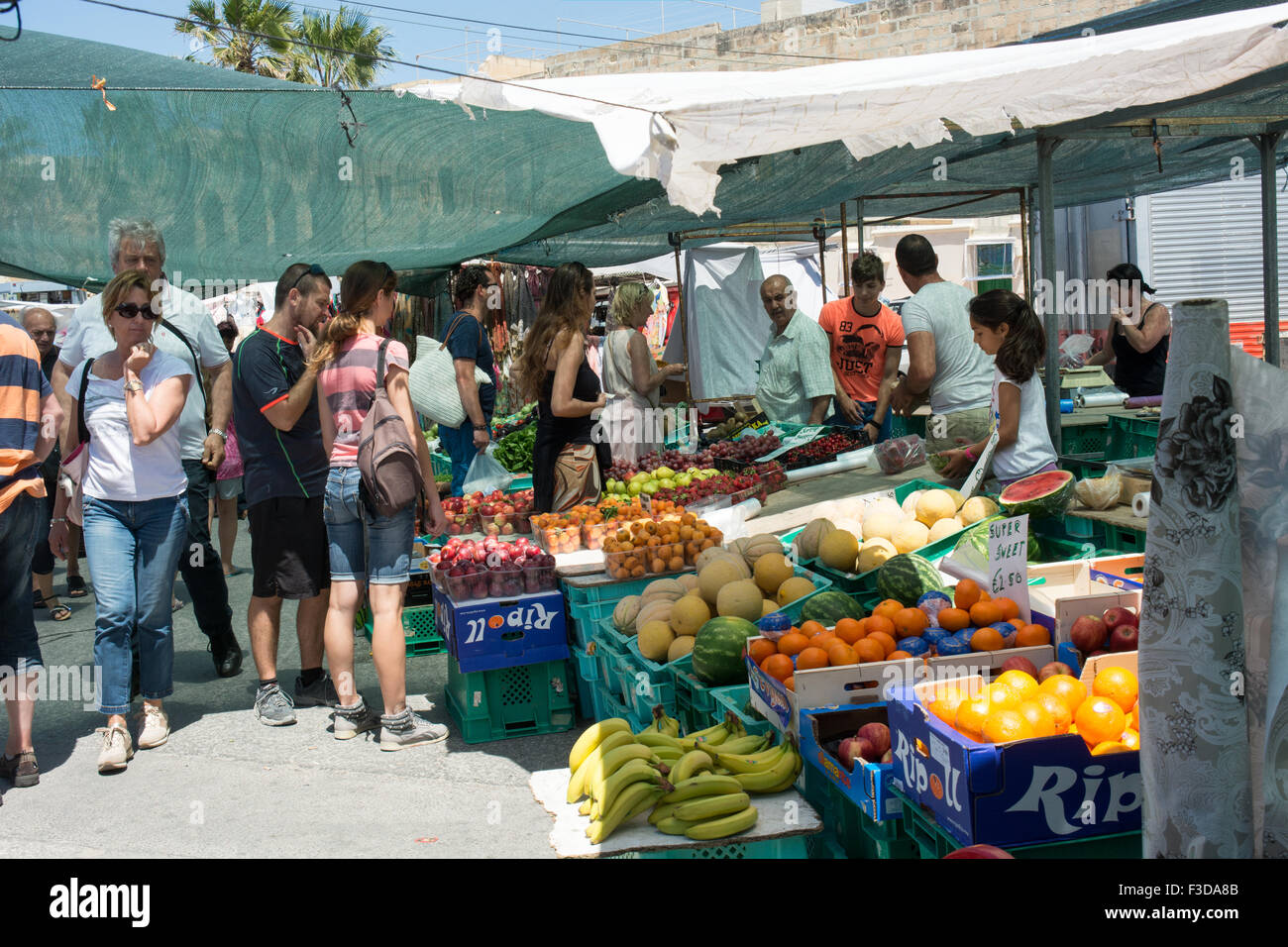 Tourists and locals shopping at the Sunday morning market held in ...