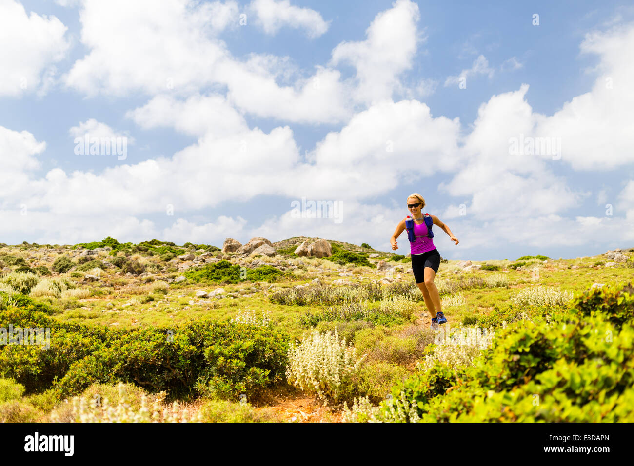 Trail running woman cross country running in inspirational mountain ...