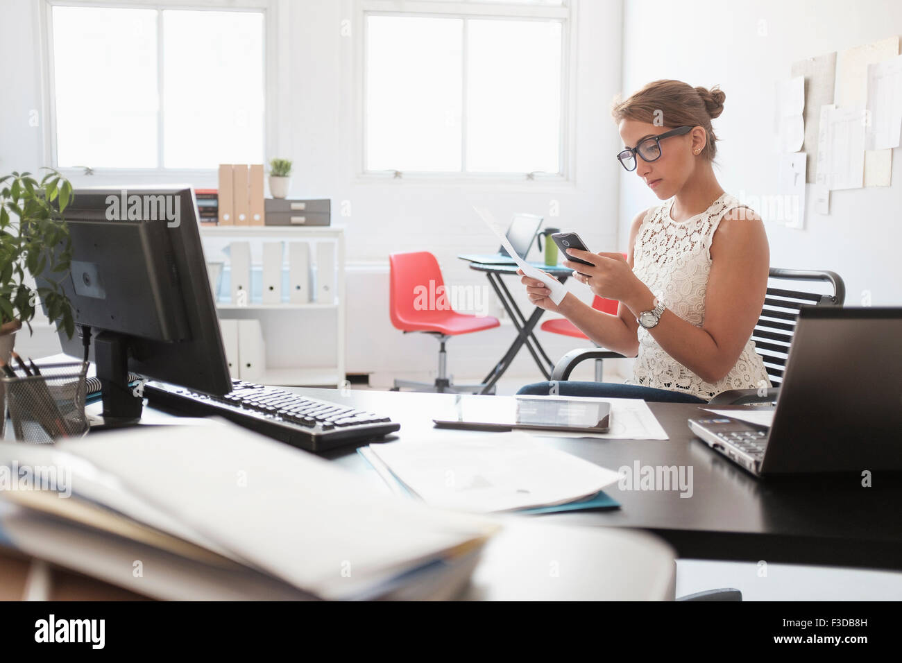 Young woman working in office Stock Photo - Alamy