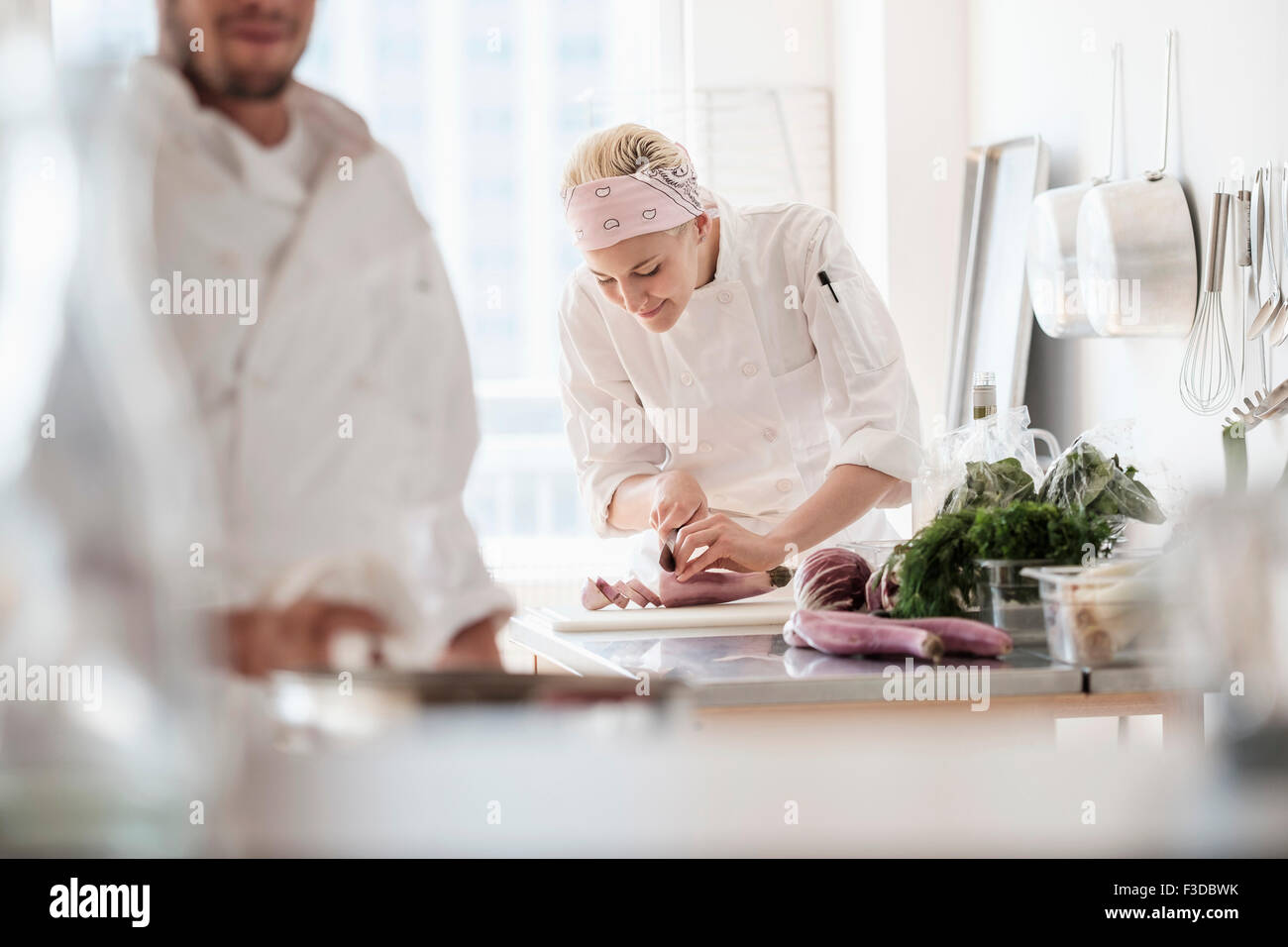 Chefs working in kitchen Stock Photo - Alamy