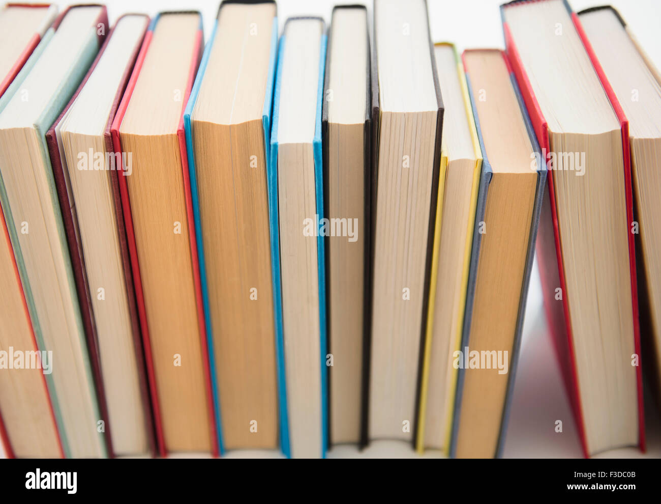 Row of books on white background Stock Photo - Alamy