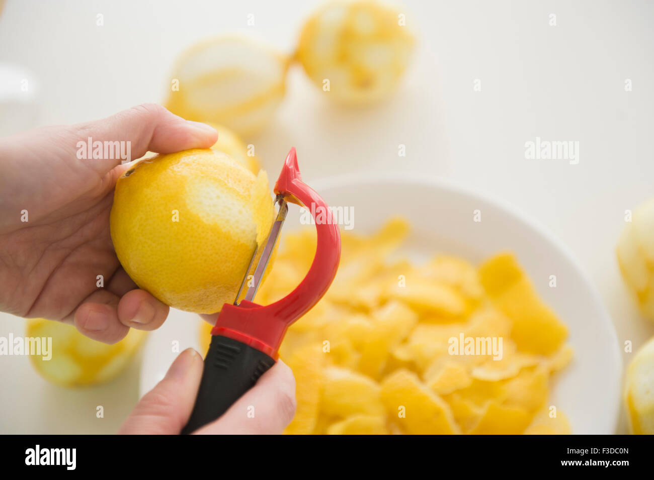Personal point of view of person peeling lemons Stock Photo - Alamy
