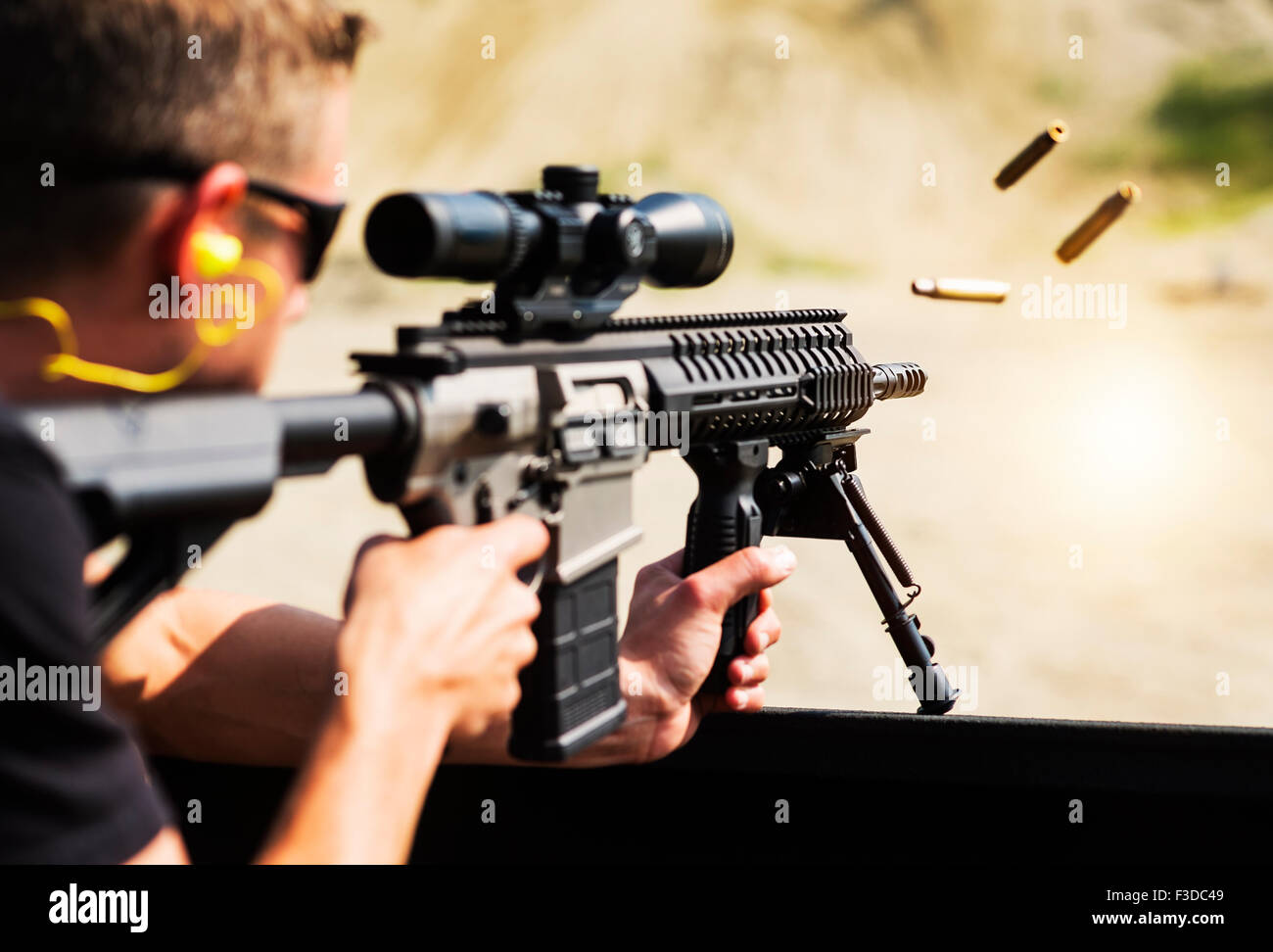Young man shooting rifle hi-res stock photography and images - Alamy
