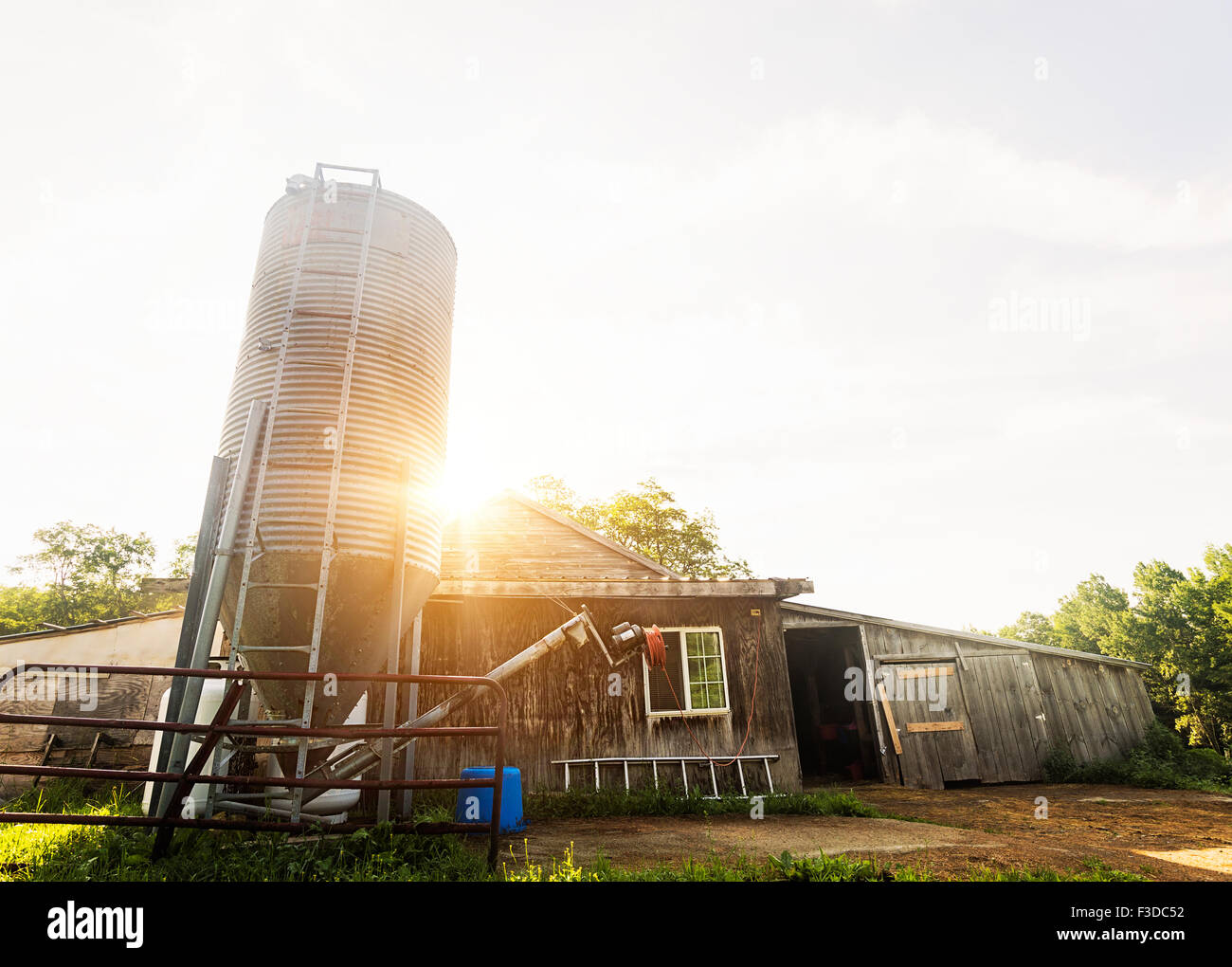 Sun shining over farm Stock Photo - Alamy