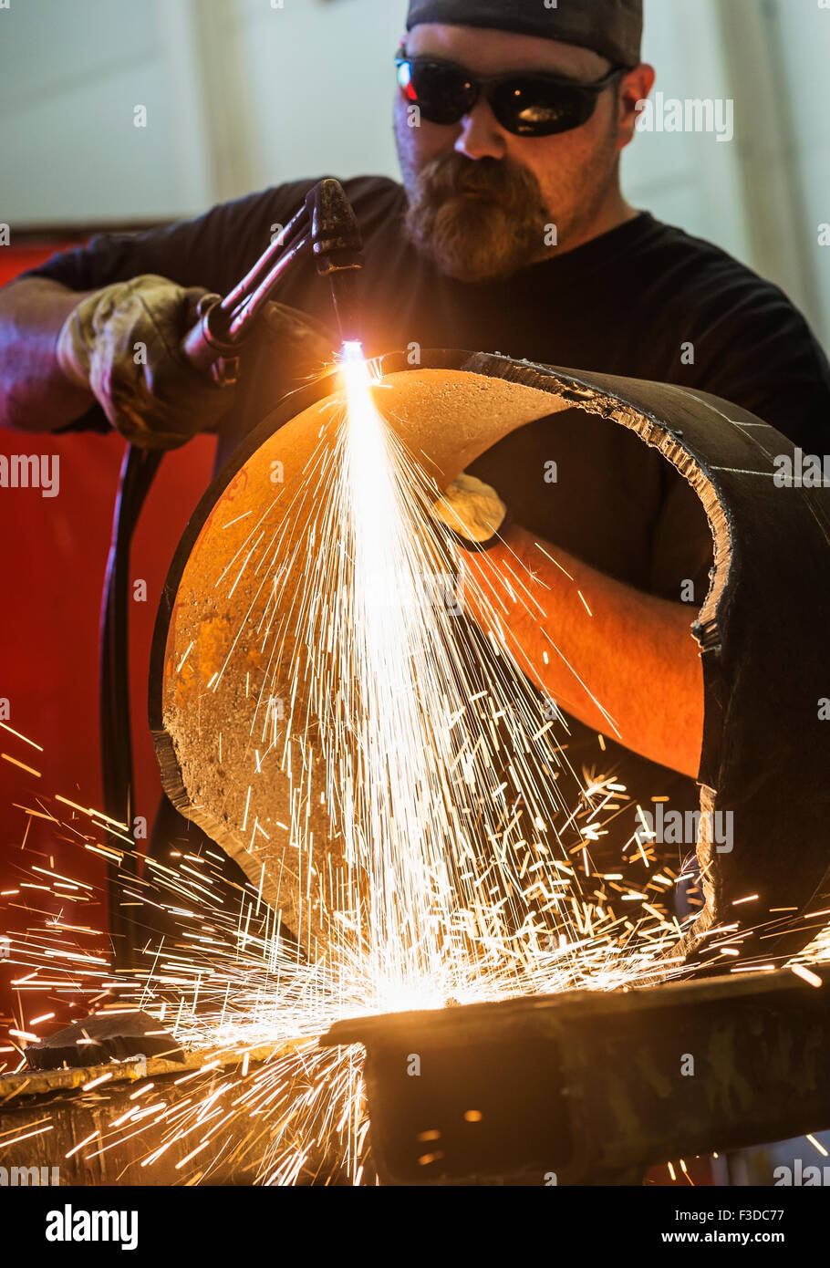 Welder working in metal workshop Stock Photo - Alamy