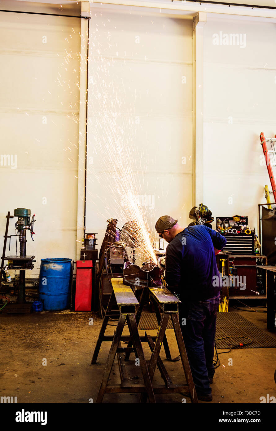 Welder working in metal workshop Stock Photo - Alamy