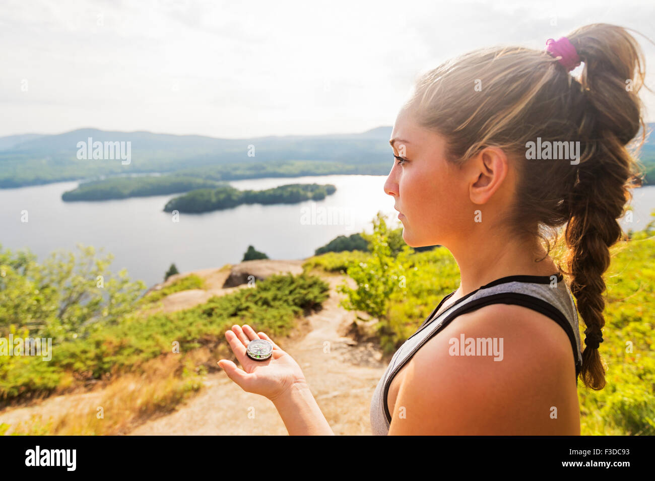 Young woman holding compass Stock Photo - Alamy