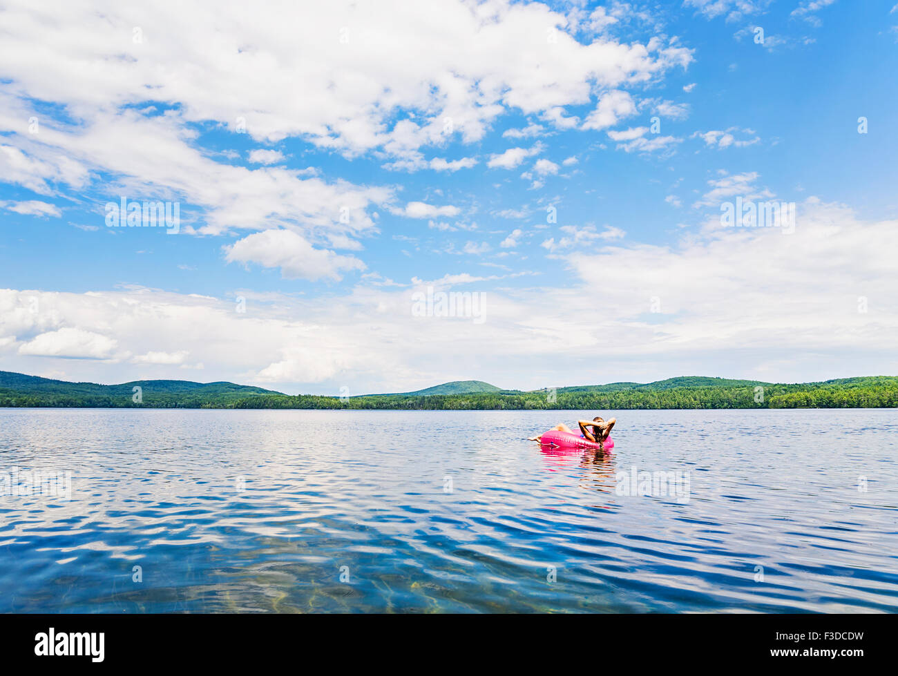 Young woman relaxing on lake in pool raft Stock Photo - Alamy