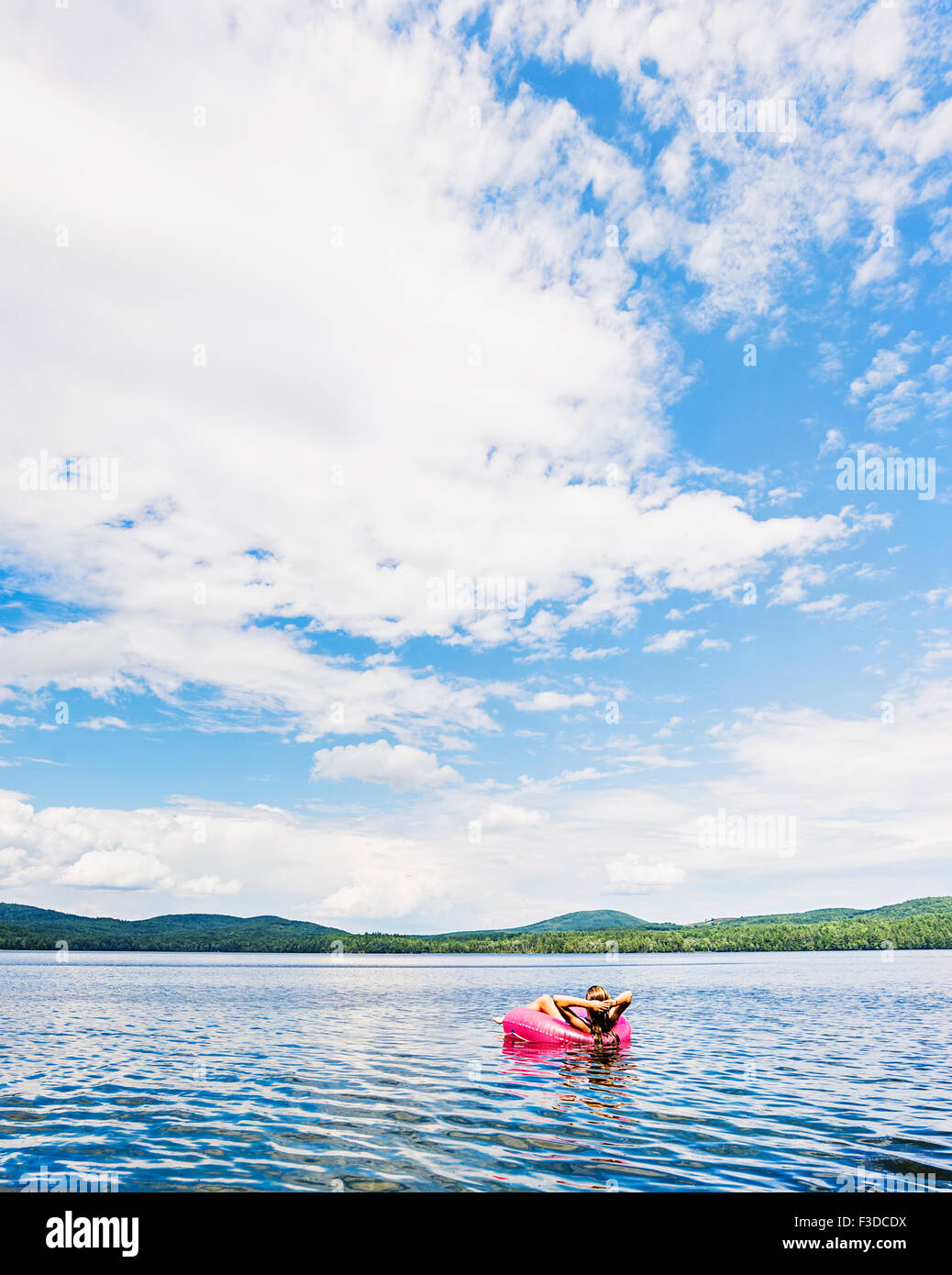 Young woman relaxing on lake in pool raft Stock Photo - Alamy