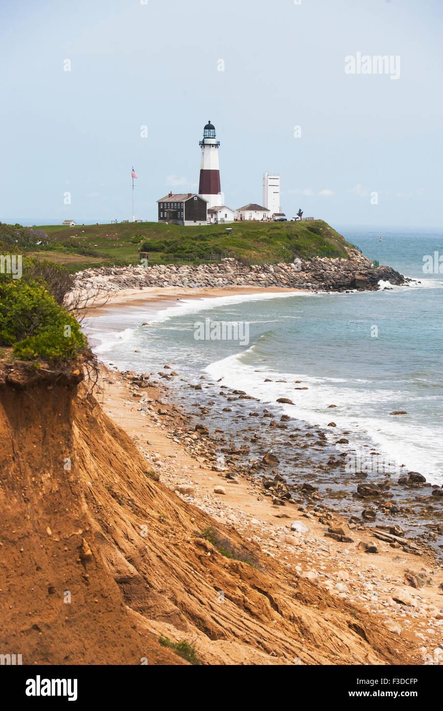 Lighthouse on cliff over sea Stock Photo - Alamy