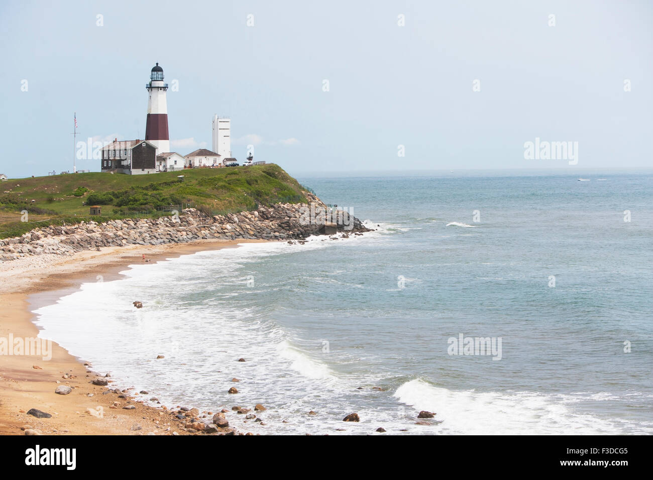 Lighthouse on cliff over sea Stock Photo - Alamy