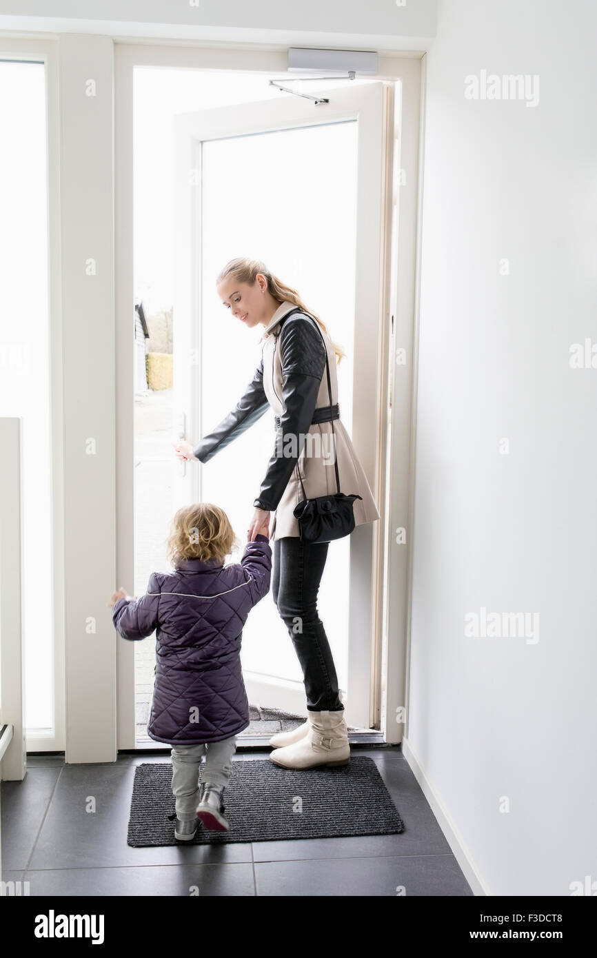 Young woman leaving house with sister (4-5 Stock Photo - Alamy