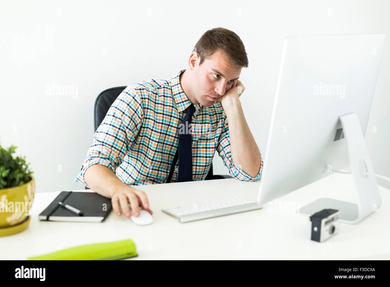 Young man working in office Stock Photo - Alamy