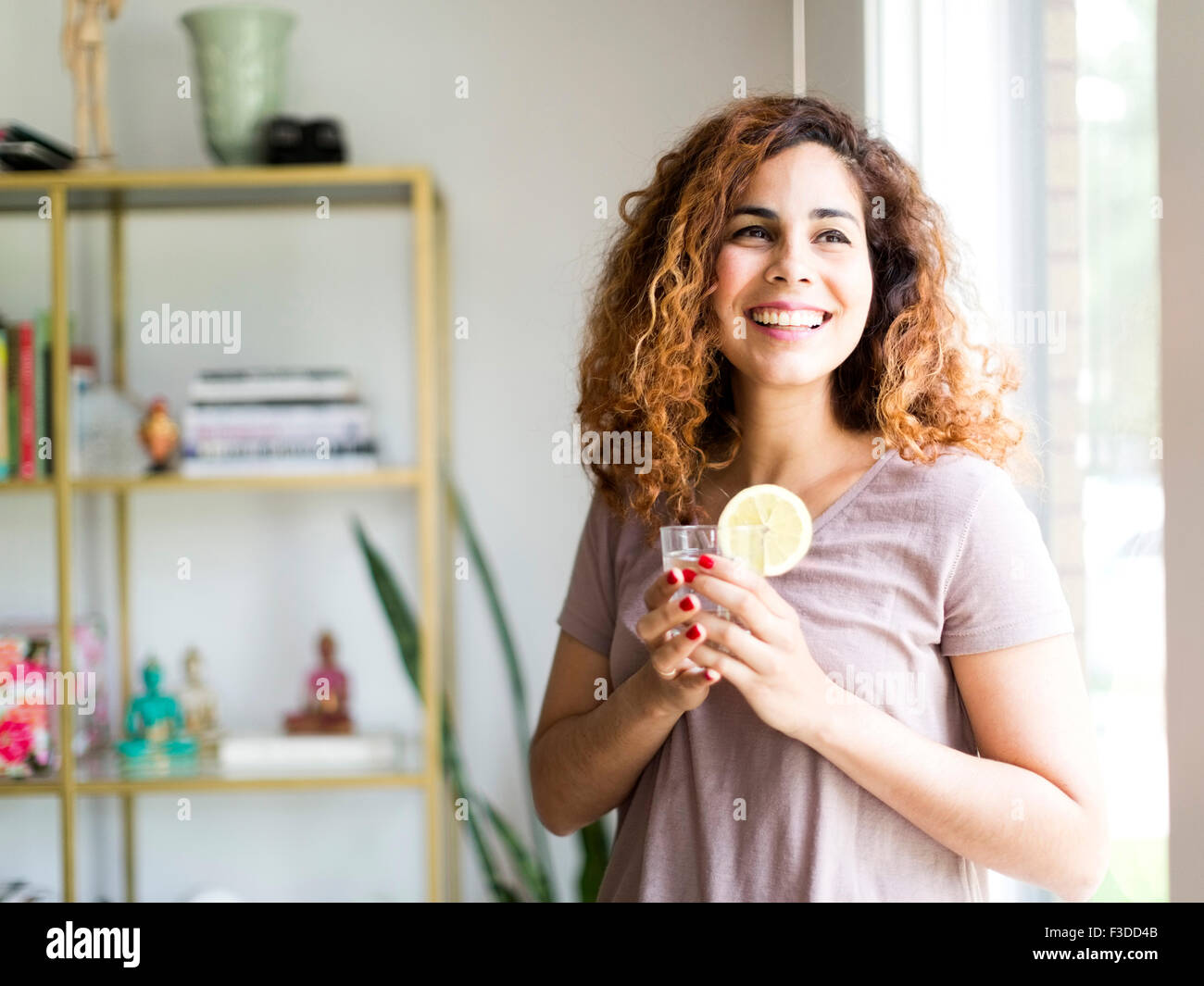 Woman holding drinking glass hi-res stock photography and images - Alamy