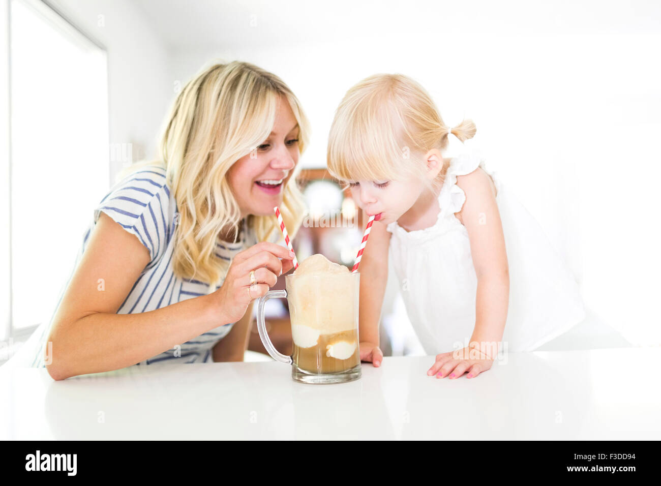 Mother drinking milkshake with daughter (2-3 Stock Photo - Alamy