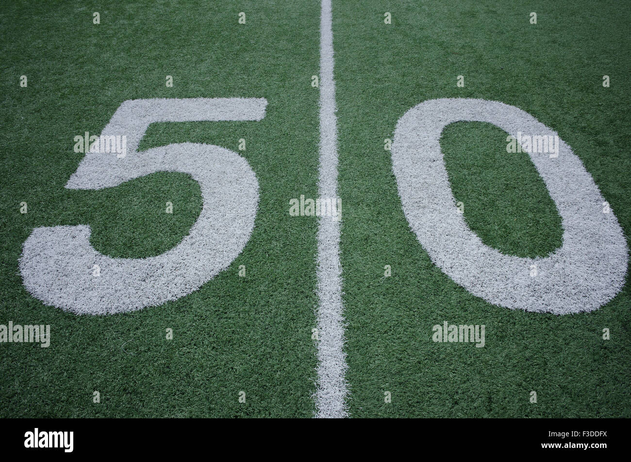 Football field marking of 50 yard line Stock Photo - Alamy