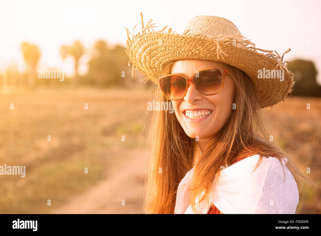 Beautiful young woman portrait in a country road Stock Photo - Alamy