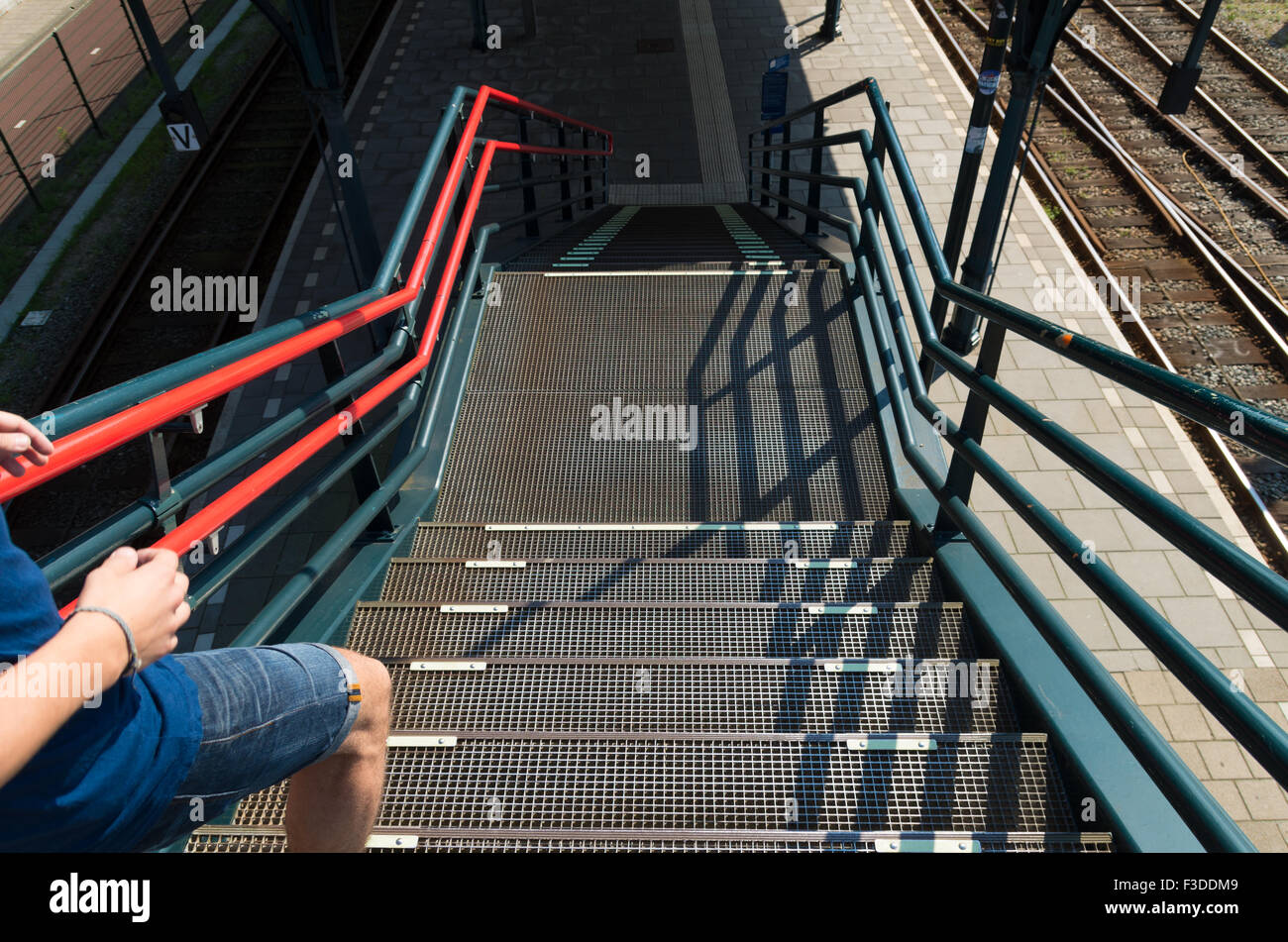 metal stairs leading down to a train platform Stock Photo - Alamy