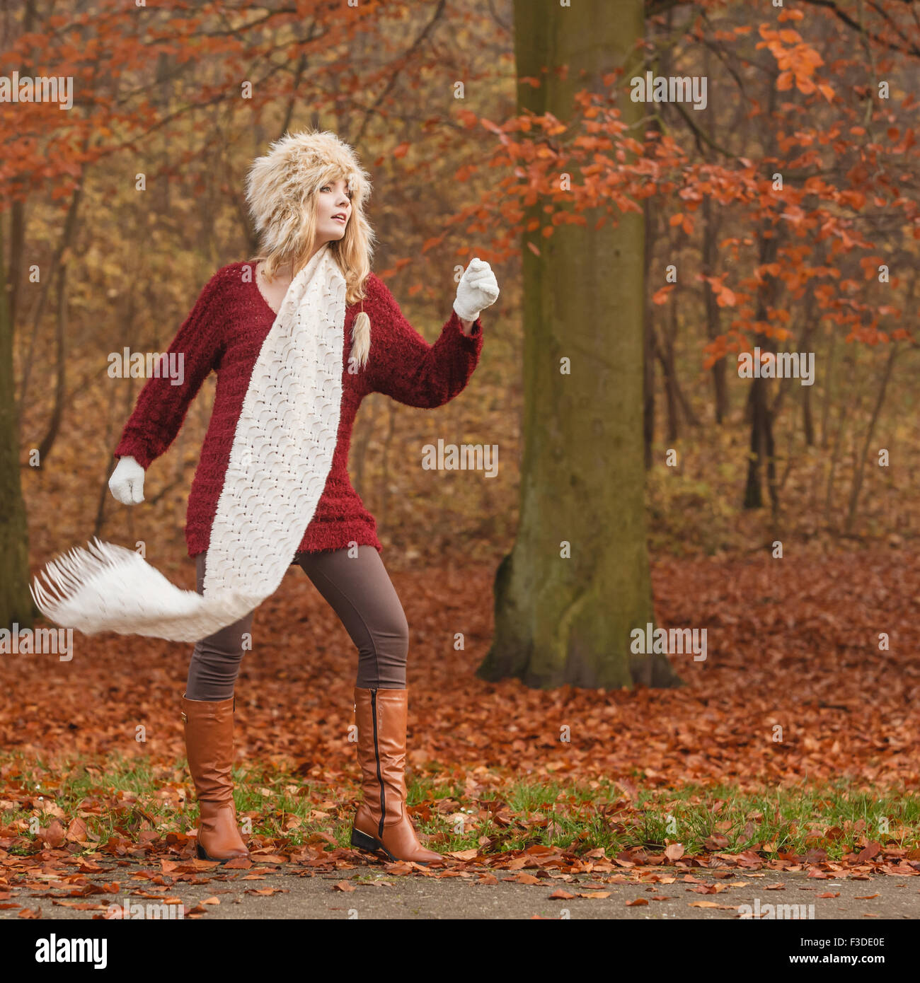 Fashion woman with flying scarf in windy fall autumn park forest ...
