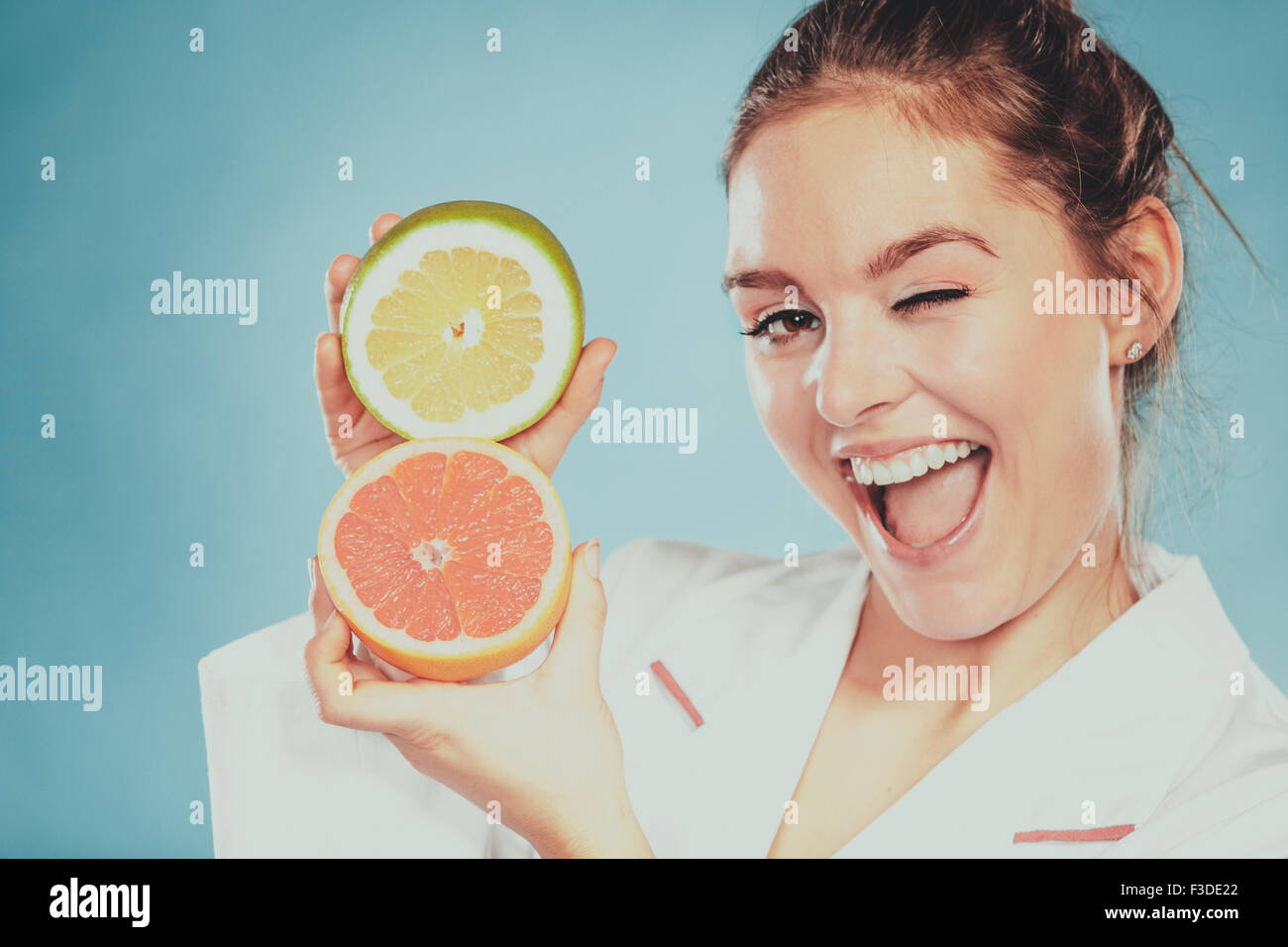 Happy dietitian nutritionist holding grapefruit having fun. Woman ...