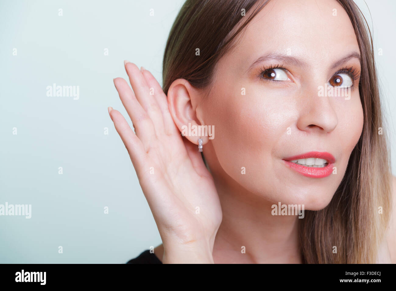 Gossip girl eavesdropping with hand to ear. Woman overhearing listening ...