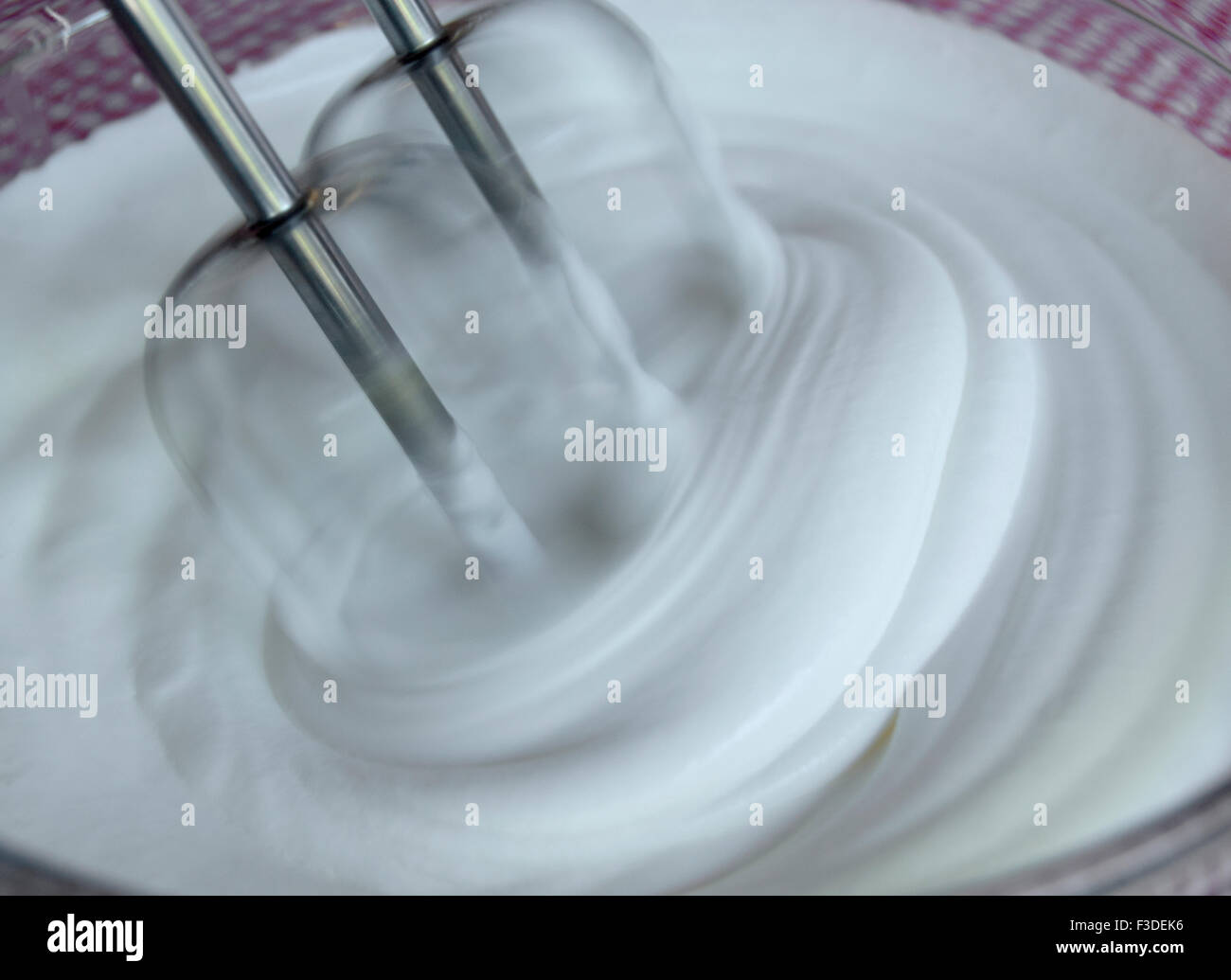 Whipped cream being blended Stock Photo - Alamy