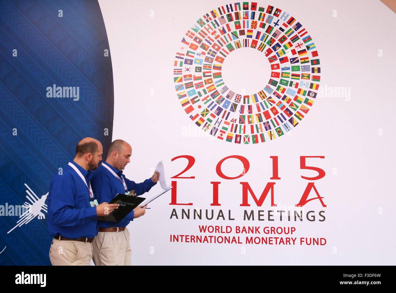 Lima, Peru. 5th Oct, 2015. People walk past a poster of the World Bank ...