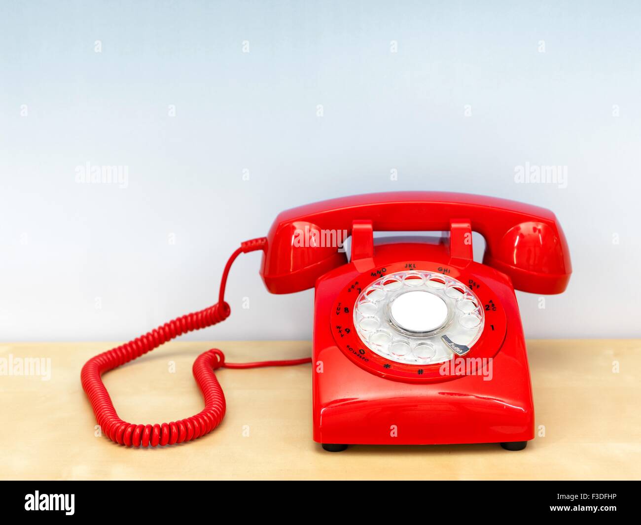 A close up photo of a red rotary phone Stock Photo - Alamy