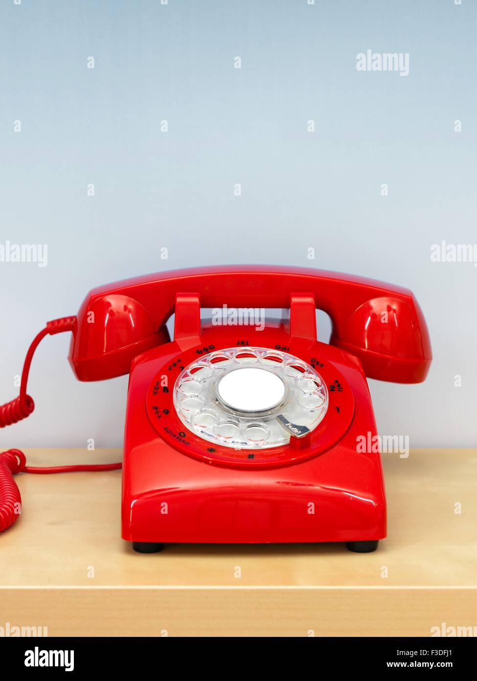 A close up photo of a red rotary phone Stock Photo - Alamy