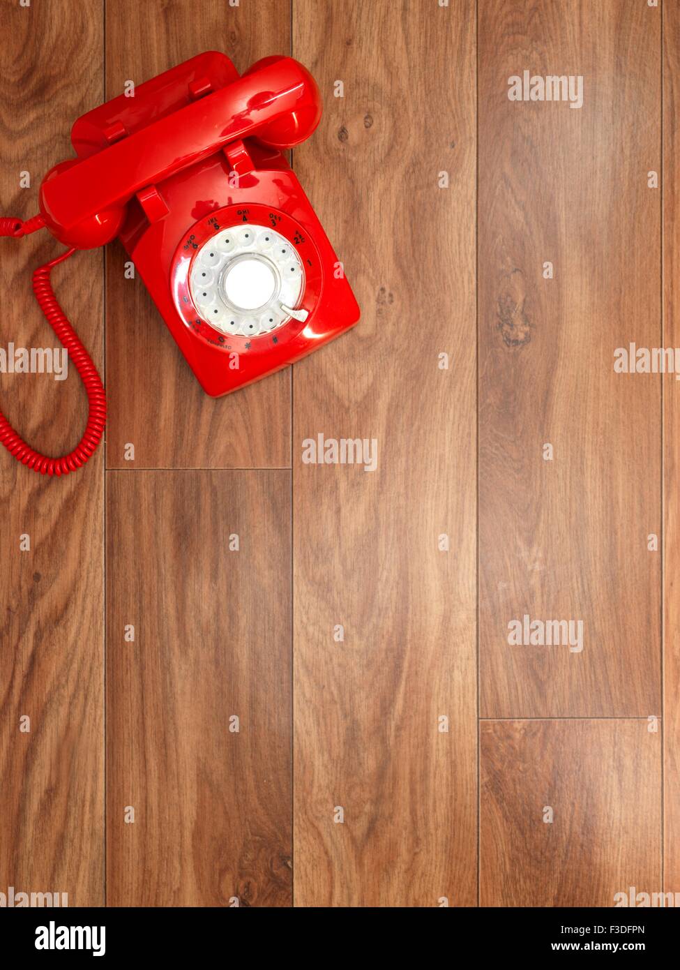 A close up photo of a red rotary phone Stock Photo - Alamy
