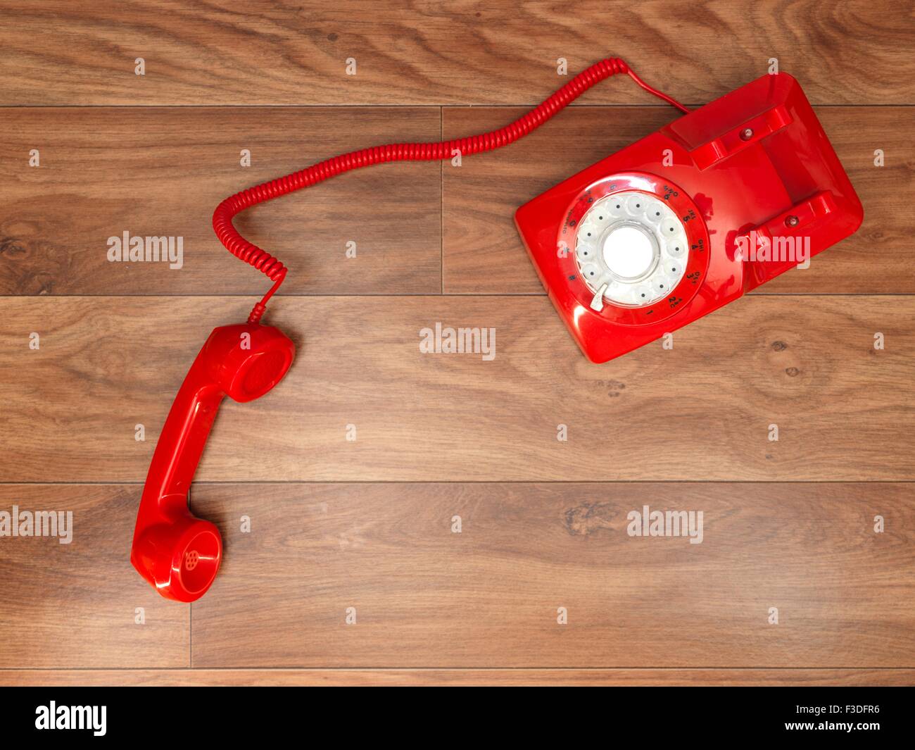 A close up photo of a red rotary phone Stock Photo - Alamy