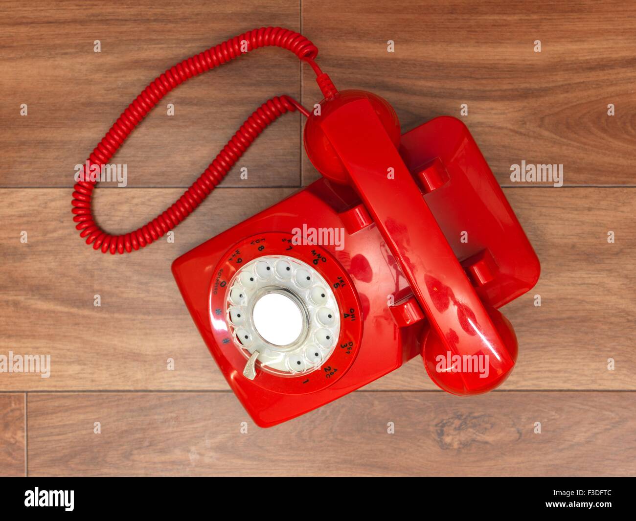 A close up photo of a red rotary phone Stock Photo - Alamy