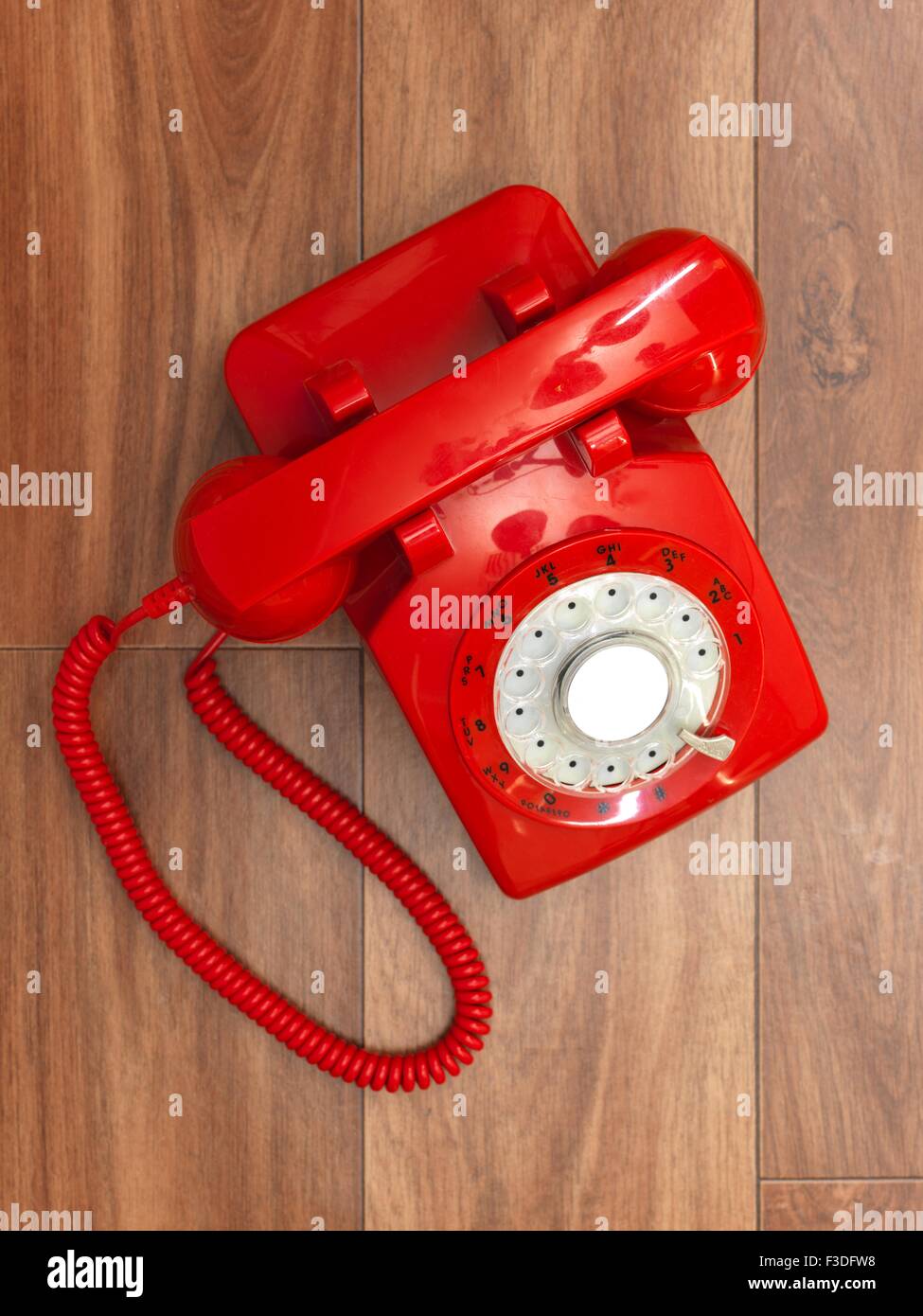 A close up photo of a red rotary phone Stock Photo - Alamy