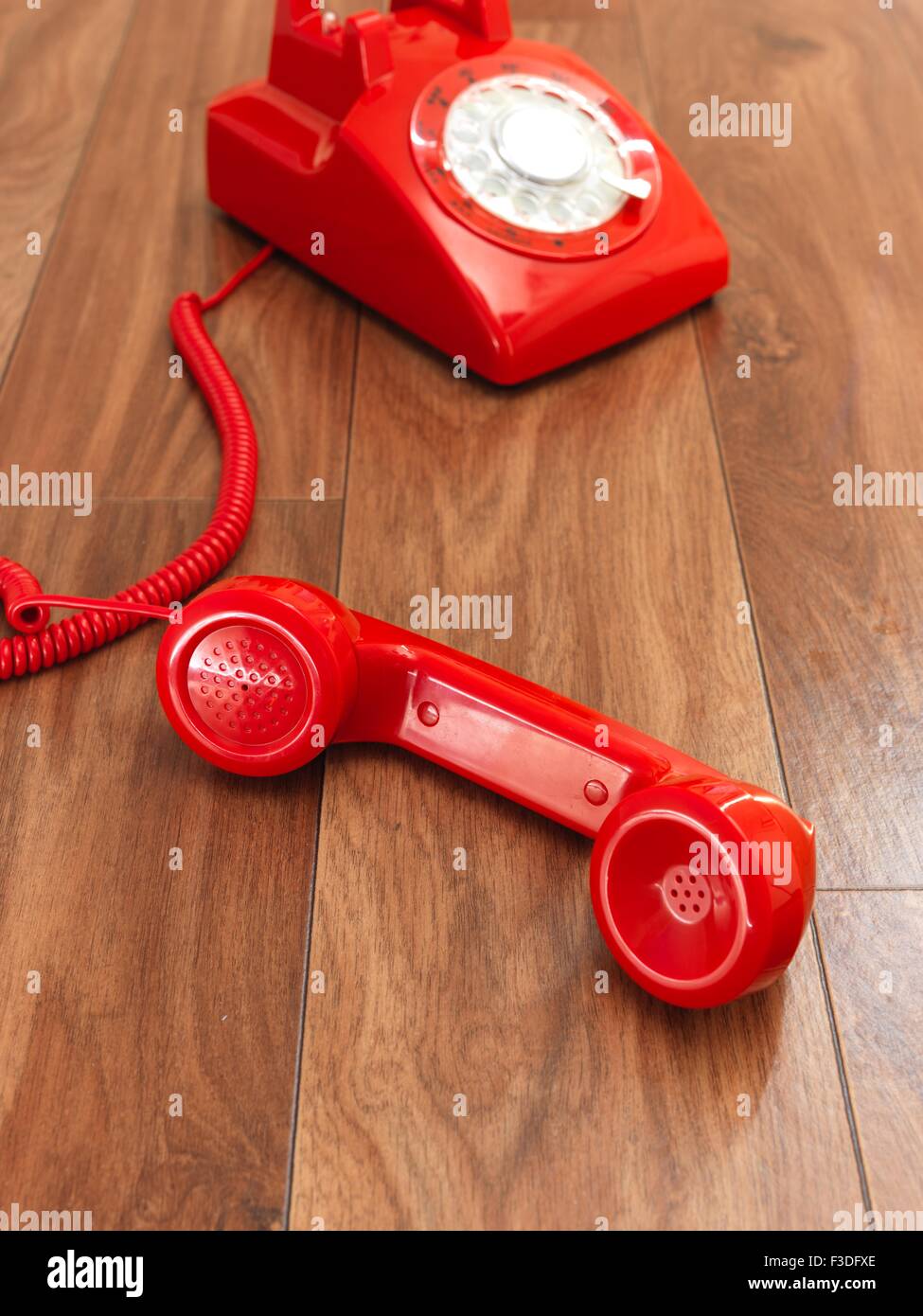A close up photo of a red rotary phone Stock Photo - Alamy