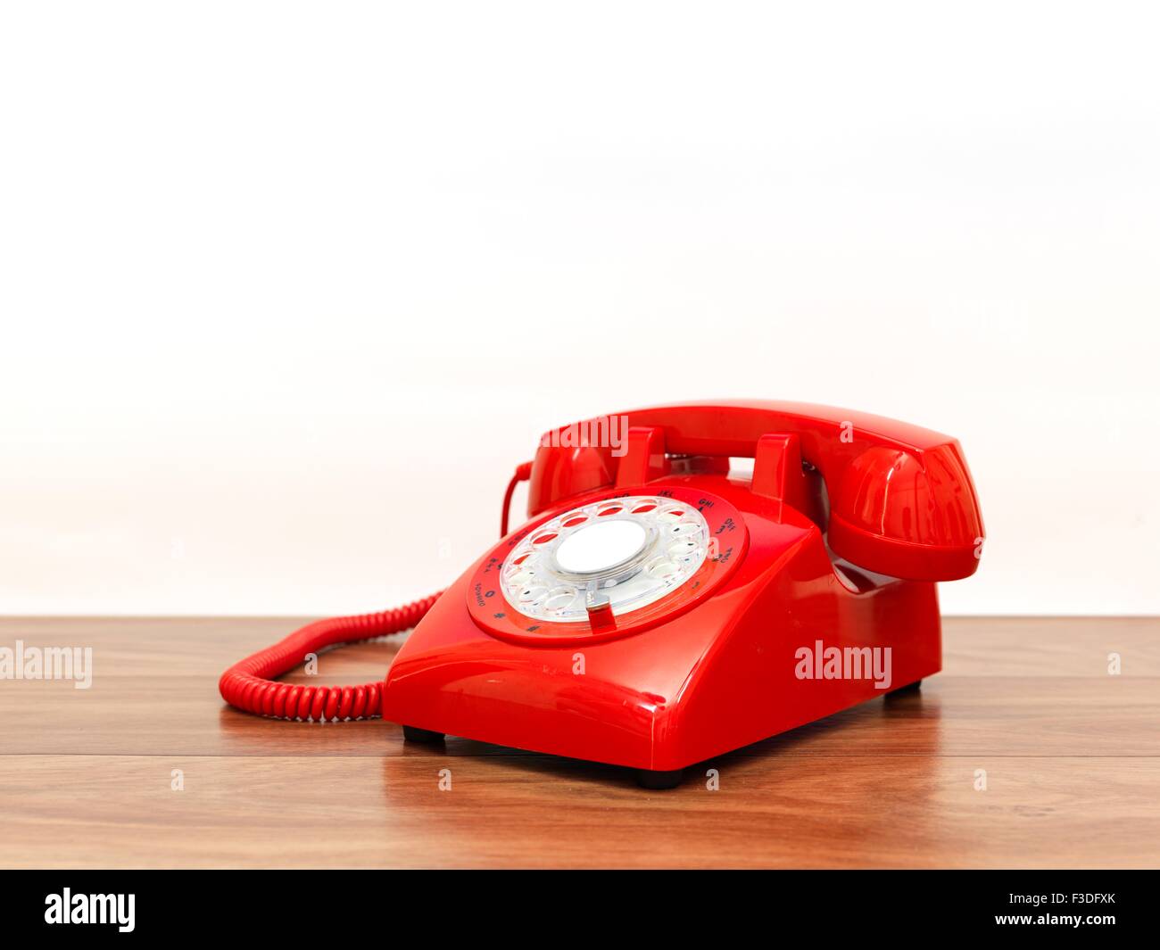 A close up photo of a red rotary phone Stock Photo - Alamy