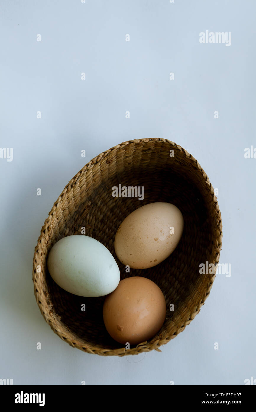 three different eggs in a basket Stock Photo - Alamy