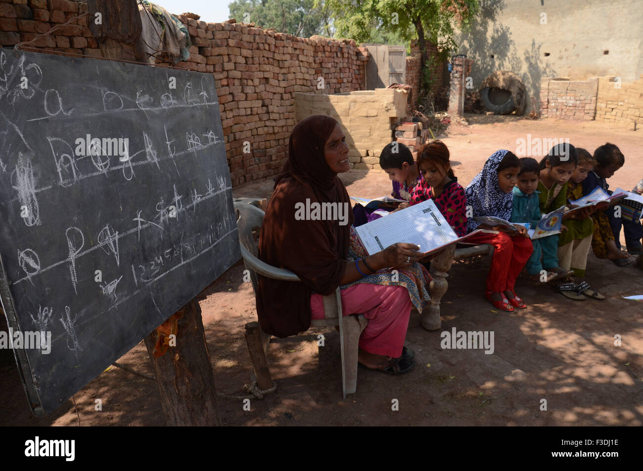 Pakistani teacher teaches students at bricks kiln on the eve of World ...