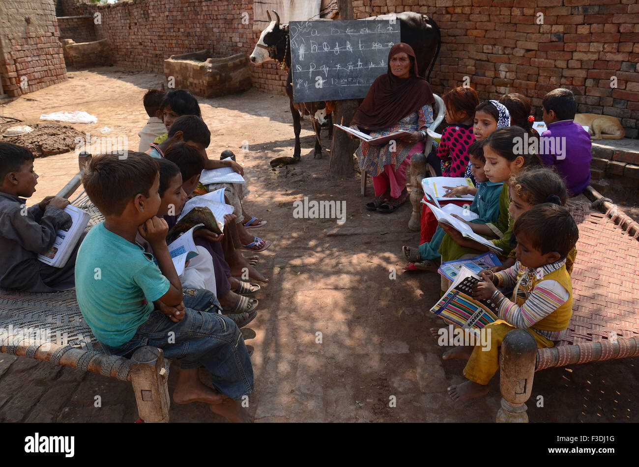 Pakistani teacher teaches students at bricks kiln on the eve of World ...