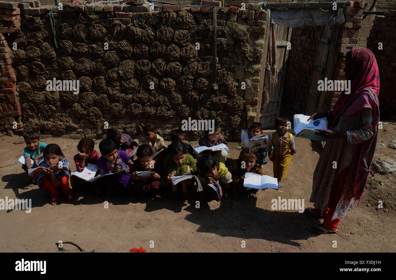 Pakistani teacher teaches students at bricks kiln on the eve of World ...