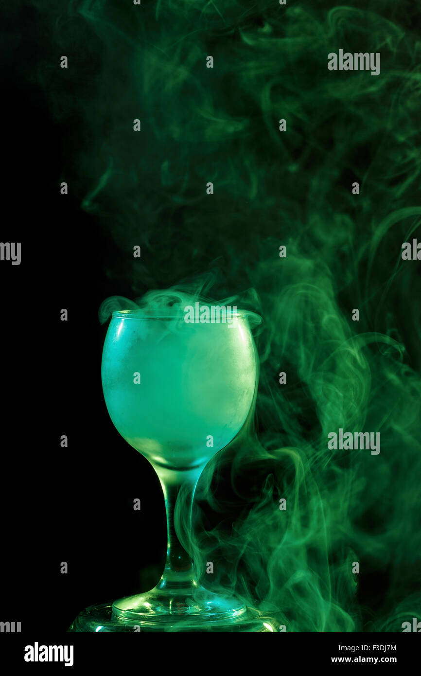 Abstract art. Hookah green smoke in cocktail glass on a white ...