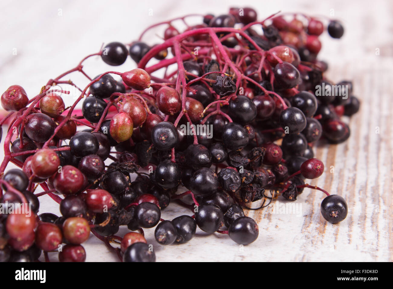 Bunch of fresh elderberry on old rustic wooden background, healthy food ...