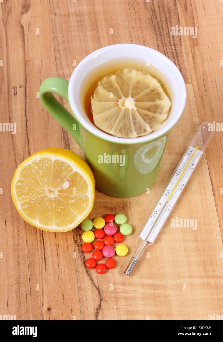 Pills, thermometer and hot tea with lemon for colds, treatment of colds ...